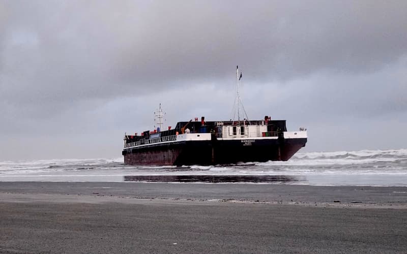 Grounded barge could be stuck at Westport beach for days | RNZ