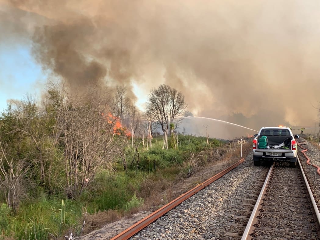 Helicopters help tackle Waikato fire which closed railway line | RNZ News