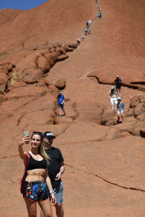 Hundreds climb Uluru on its final day before permanent closure | RNZ News