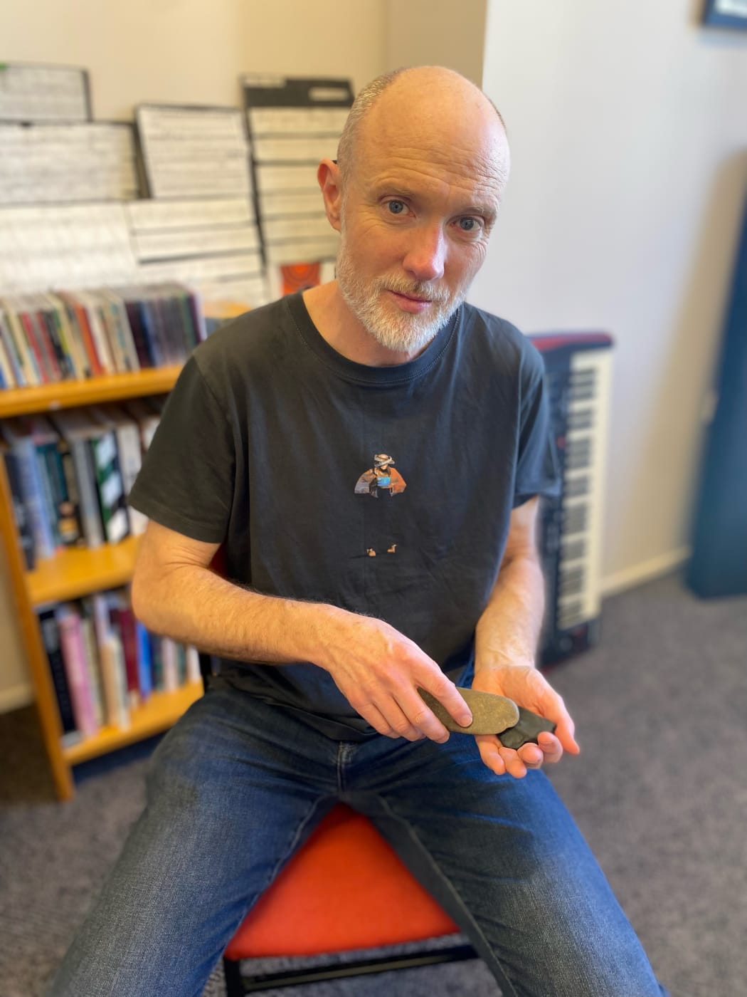 Orchestra performing with kōhatu, riverstones | RNZ