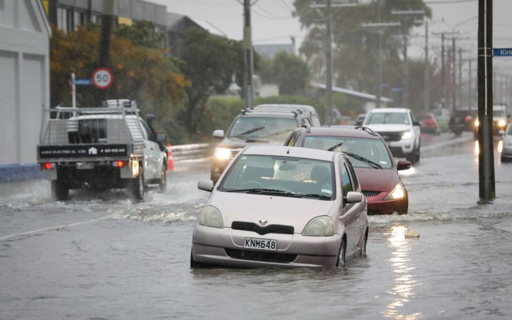 In pictures: Huge slip tears through street, Dunedin roads flood | RNZ News
