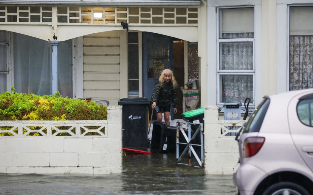 In pictures: Huge slip tears through street, Dunedin roads flood | RNZ News