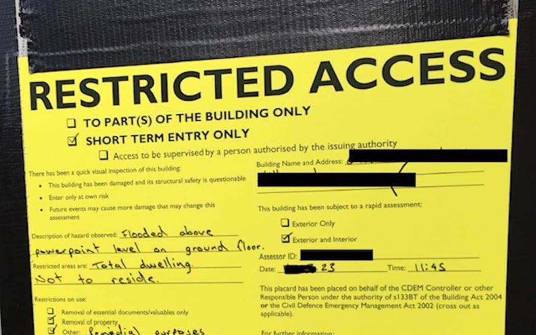 Yellow placard at flood-damaged home taken down without clear ...