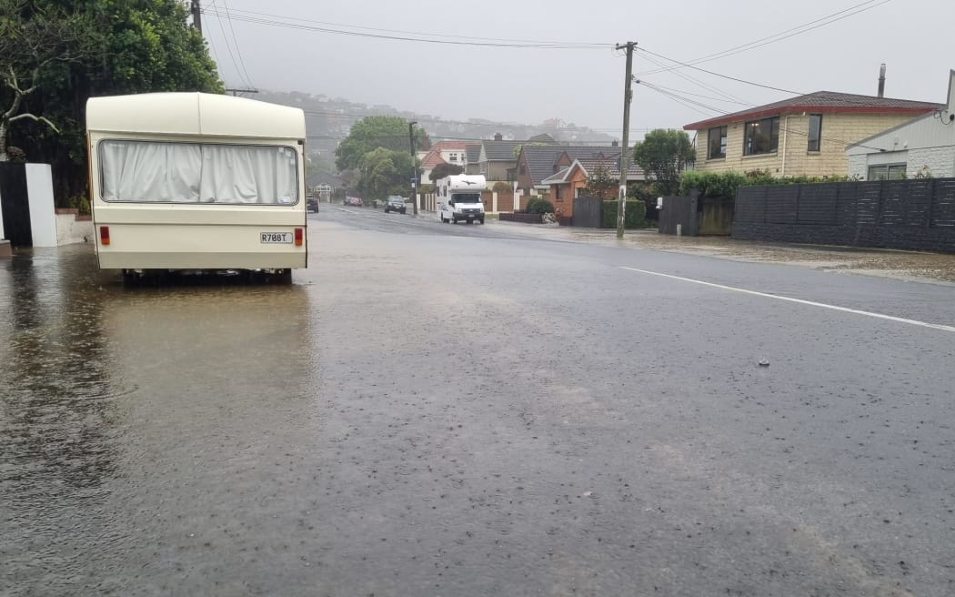 In pictures: Huge slip tears through street, Dunedin roads flood | RNZ News