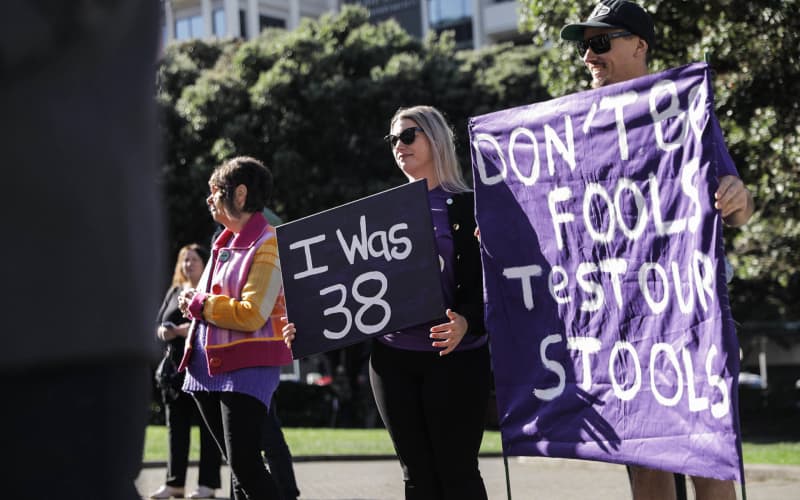 Protesters at Parliament call for lowering of age for free bowel cancer ...