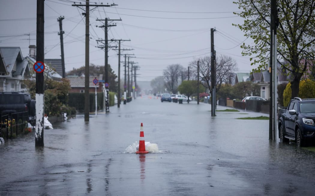 In pictures: Huge slip tears through street, Dunedin roads flood | RNZ News