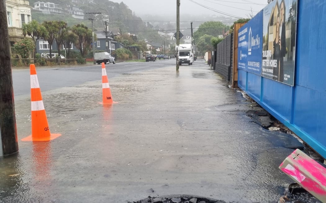 In pictures: Huge slip tears through street, Dunedin roads flood | RNZ News