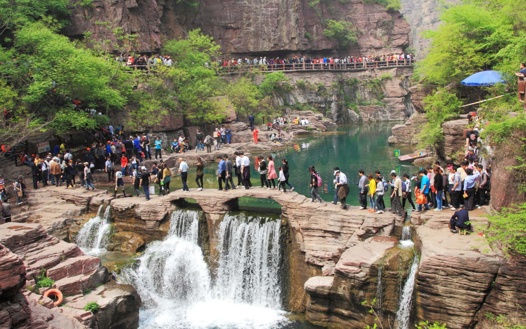 Questions after hidden pipe spotted at famous China waterfall | RNZ News