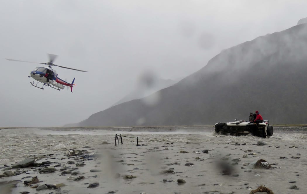 Helicopter rescues four people from 4WD roof | RNZ News